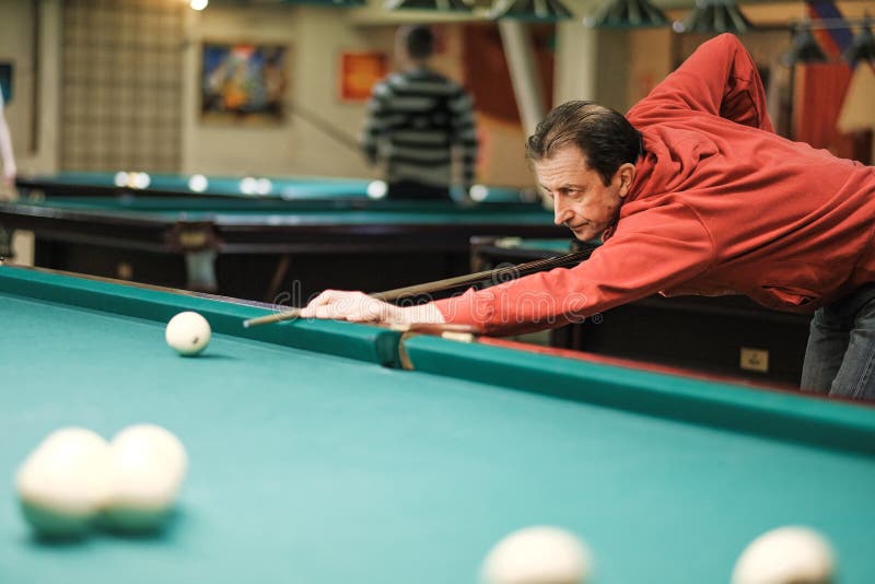 The Player Takes Aim at the Ball in Billiards Stock Photo - Image of ...