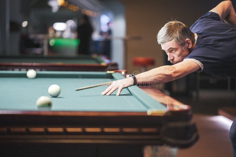The Player Takes Aim at the Ball in Billiards Stock Photo - Image of ...