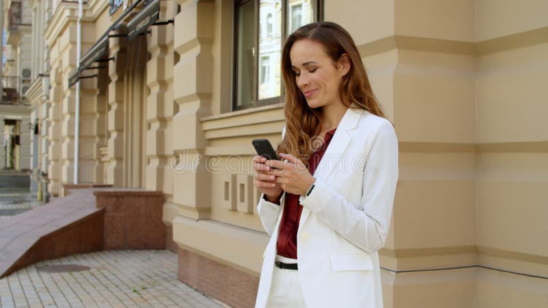 Playful Business Woman Texting On Mobile Phone Outdoors Smiling Woman