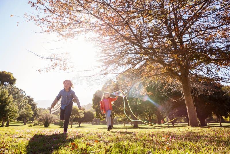 Playful Children Running in Park Stock Photo - Image of clothing ...