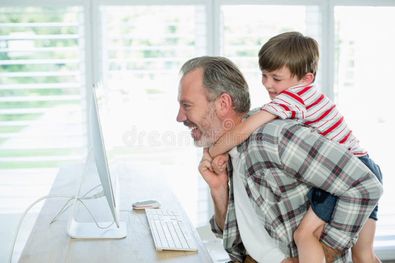 Playful Father and Son Working on Computer at Home Stock Image - Image ...