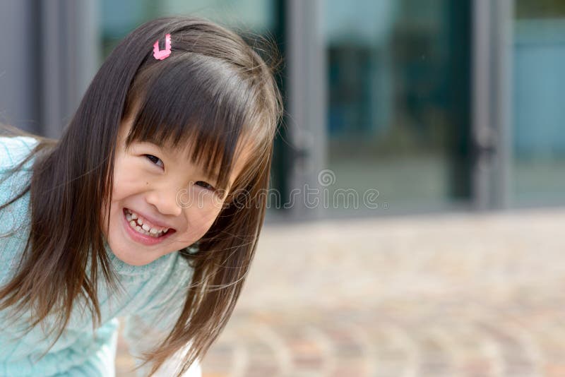 Playful Little Girl Leaning Down and Laughing Stock Image - Image of ...