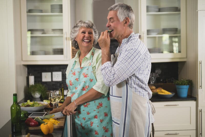 Playful Senior Couple Enjoying while Cooking in Kitchen Stock Image ...