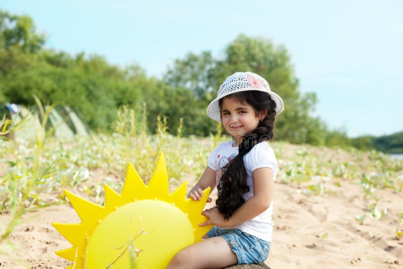 Playful Young Girl Posing with Paper Sun Stock Image - Image of ...
