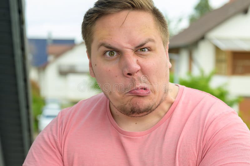 Playful Young Man Pulling An Ugly Face At The Camera Stock Image Image Of Face Outdoors
