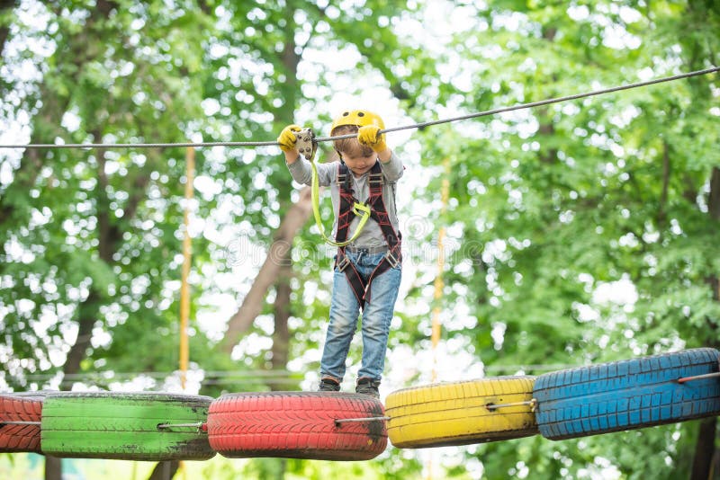 Playground. Child Climbing on High Rope Park. Cute Child Boy. Stock ...