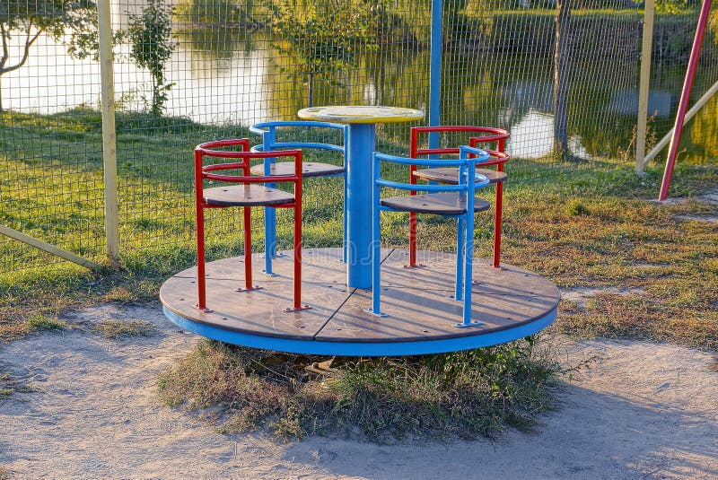 Children`s Playground with a Round Colored Carousel in the Grass Stock ...