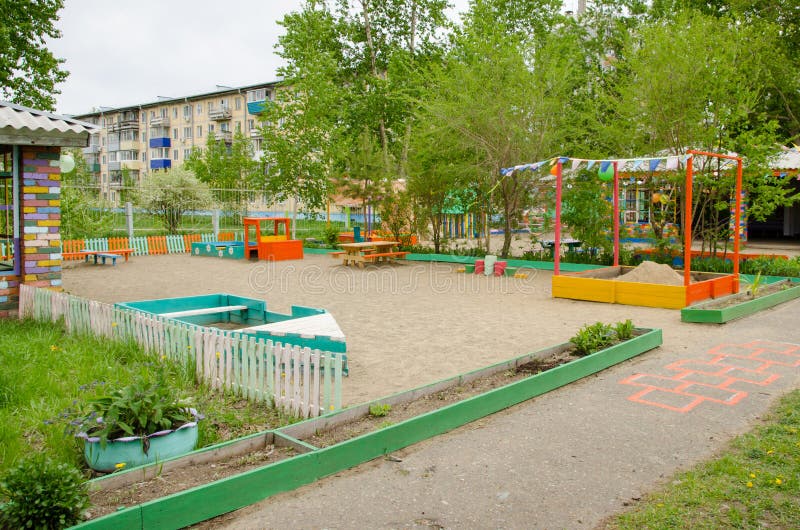 Playground with Flower Beds and Game Structures Stock Photo - Image of ...