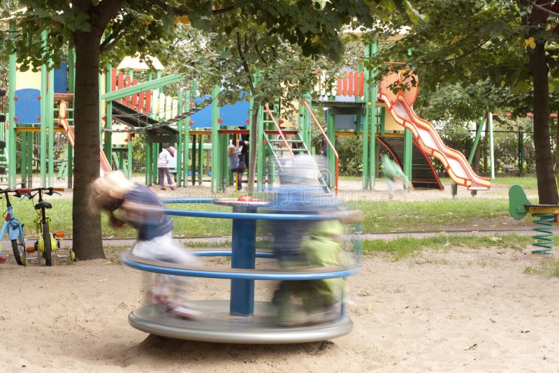 Playground with Kids and Carousel Stock Image - Image of motion ...