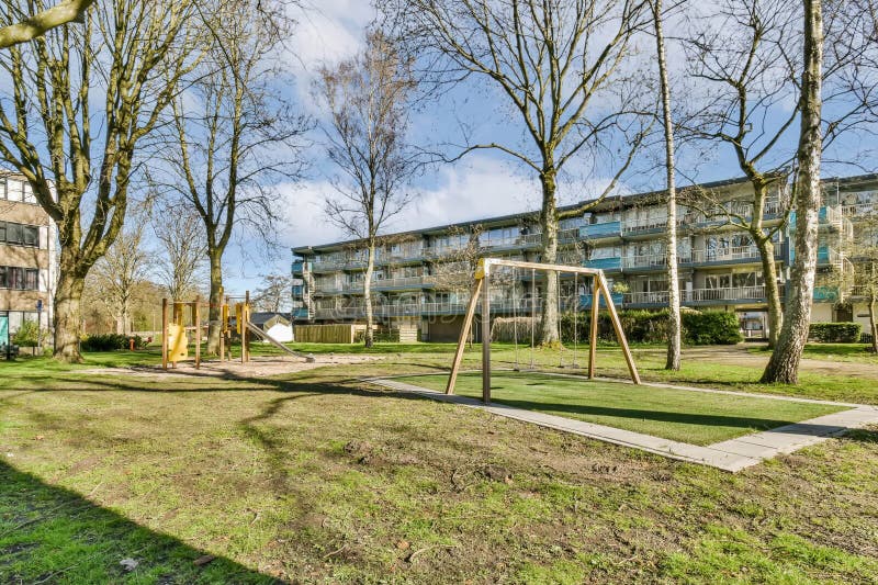 A Playground in a Park in Front of a Building Stock Photo - Image of ...