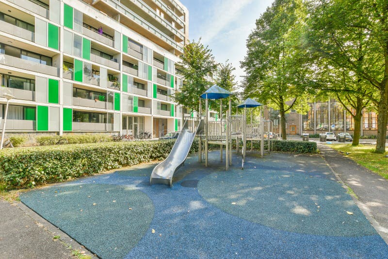 A Playground with a Slide in Front of a Building Editorial Image ...