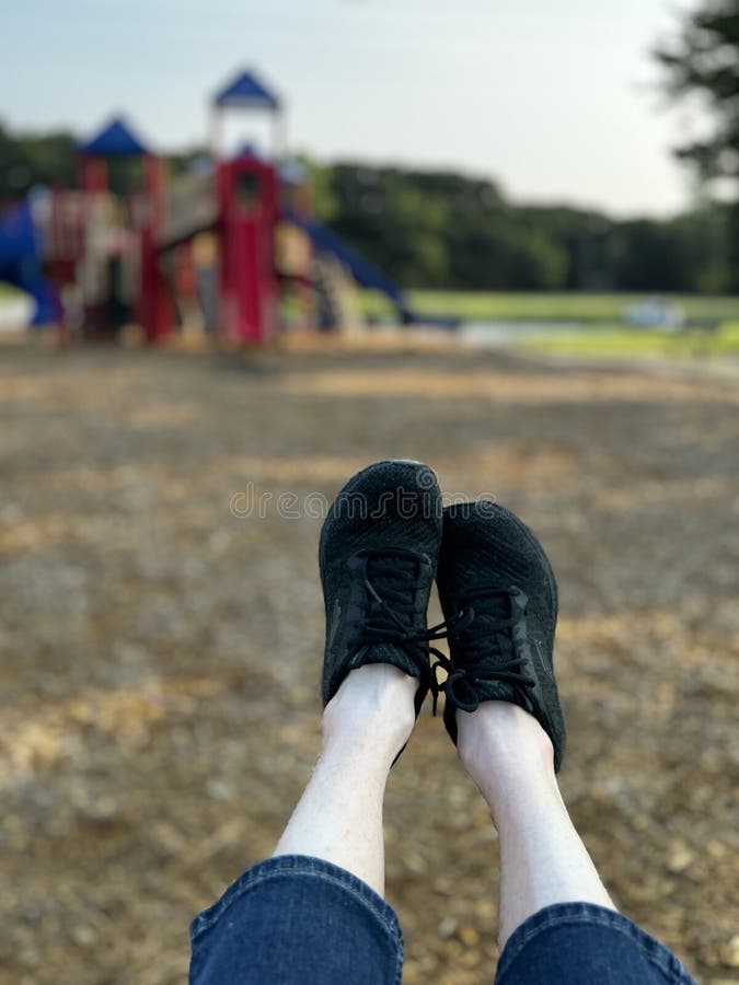 Feet Stretched Out in Swing Forward Motion .. from Playground Swings ...