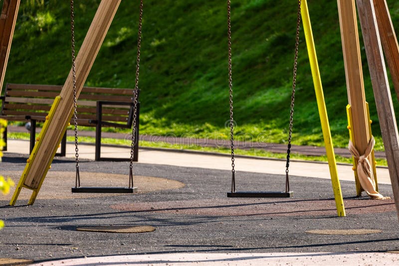Playground swing in a park stock photo. Image of view - 388610108