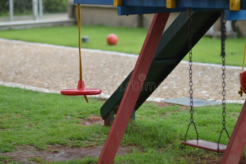 Playground with Yellow, Blue and Red Carousel Stock Image - Image of ...