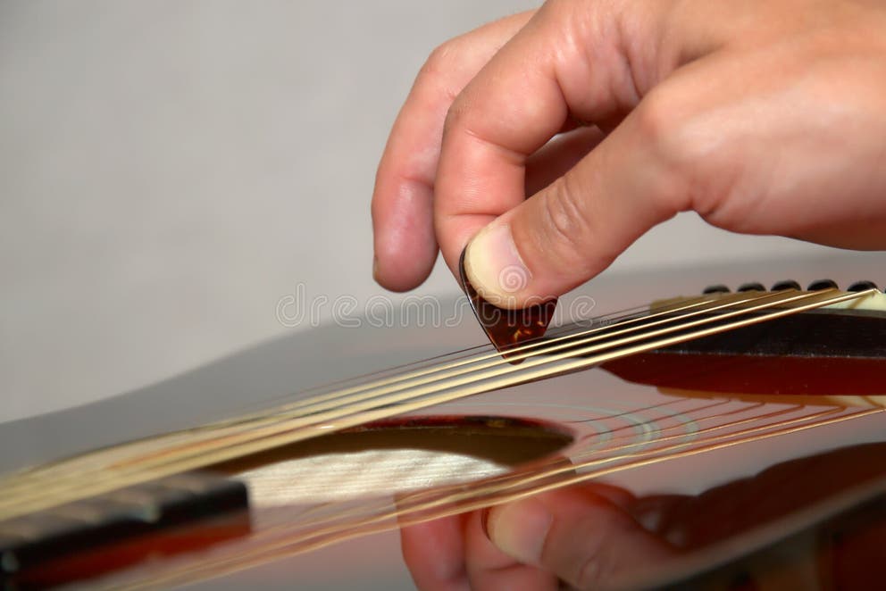 Playing Acoustic Guitar: Hand with Pick on Strings Stock Image - Image ...