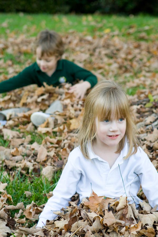 Playing in the Autumn Leaves Stock Photo - Image of friends, happiness ...