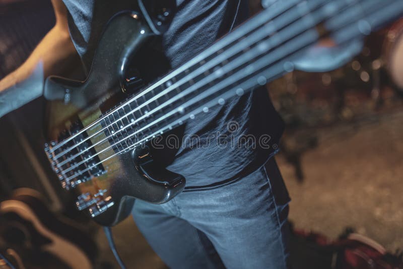 Playing the Bass Guitar stock image. Image of electric - 321933529