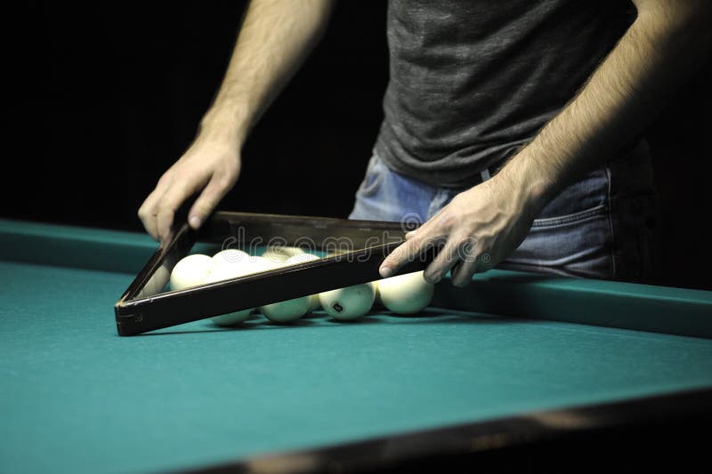 Playing Billiard: Player Setting Up Balls for the Beginning of Game ...
