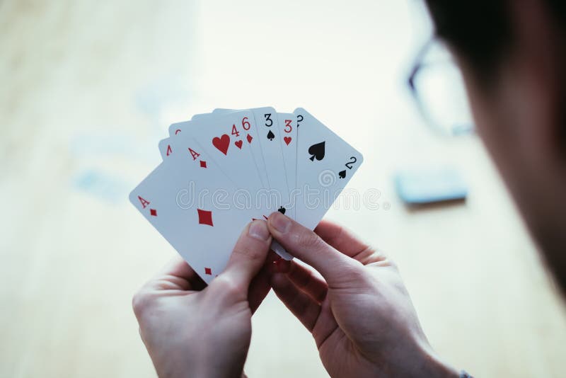 Playing Cards: Poker Cards in the Hand of a Young Man Stock Image ...