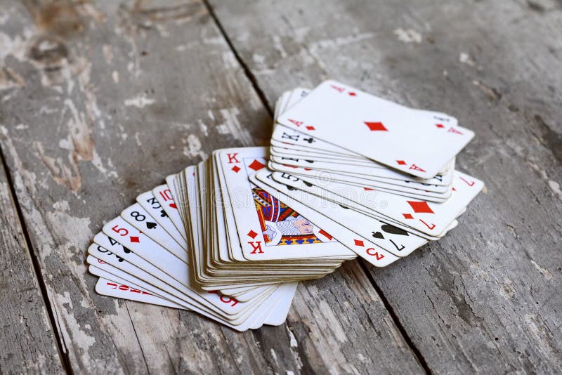 Playing Cards on a Rustic Wooden Table. Stock Photo - Image of hand ...