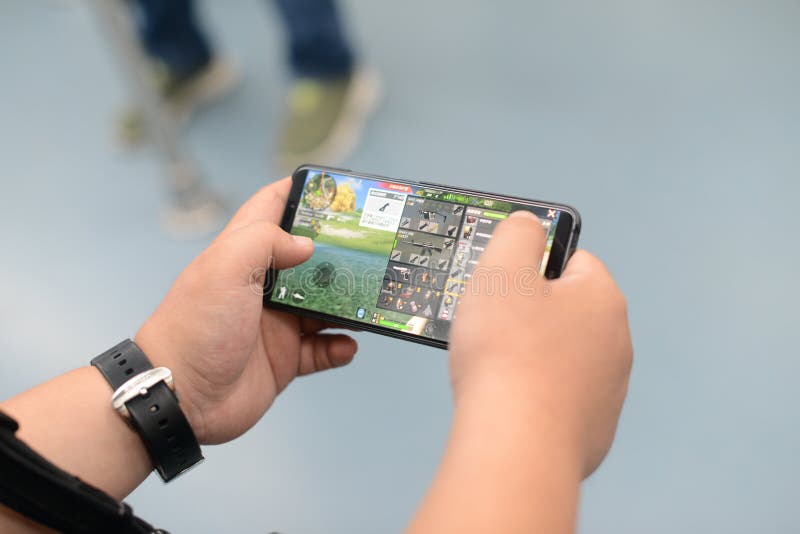 Playing Games In Cell Phone Stock Image - Image of home, lying: 21434703