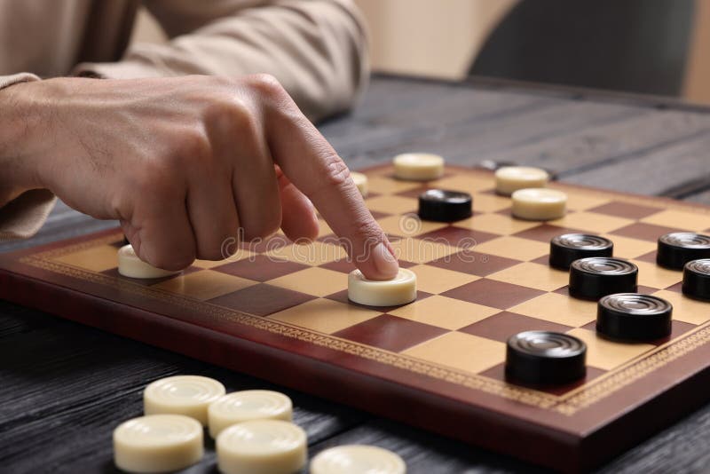 Playing Checkers. Man Thinking about Next Move at Wooden Table, Closeup ...