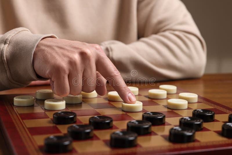 Playing Checkers. Man Thinking about Next Move at Wooden Table, Closeup ...