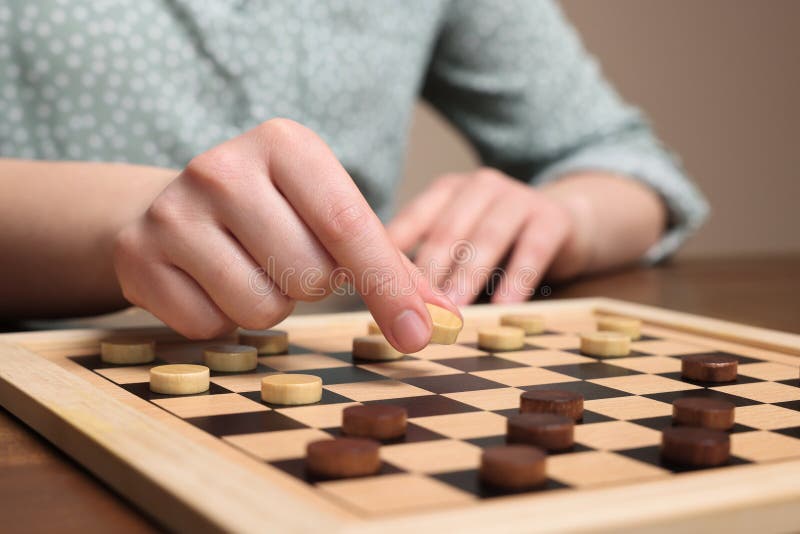 Playing Checkers. Woman Thinking about Next Move at Wooden Table ...