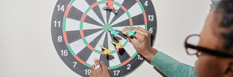 Playing Darts Game while Aiming at Target on Dartboard Stock Photo ...