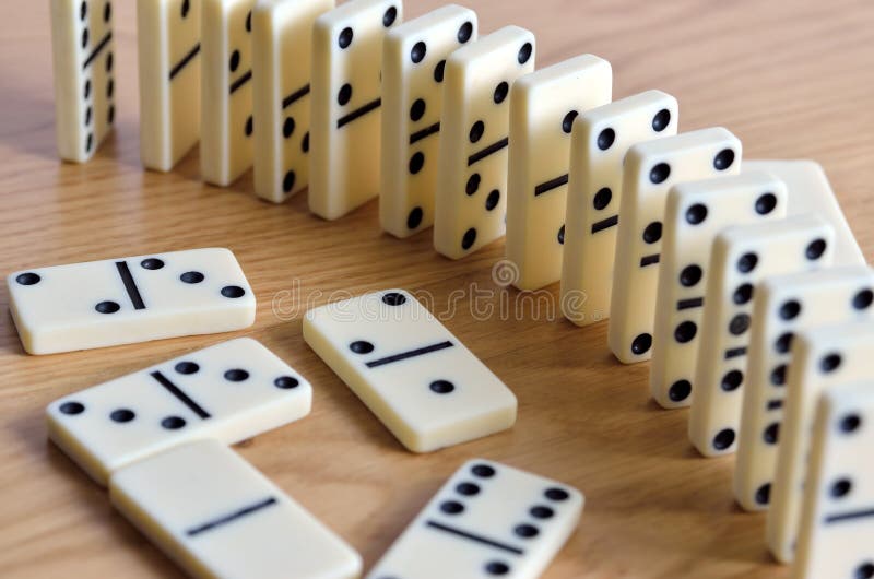 Playing Dominoes on a Wooden Table. Dominoes Game Concept Stock Image ...