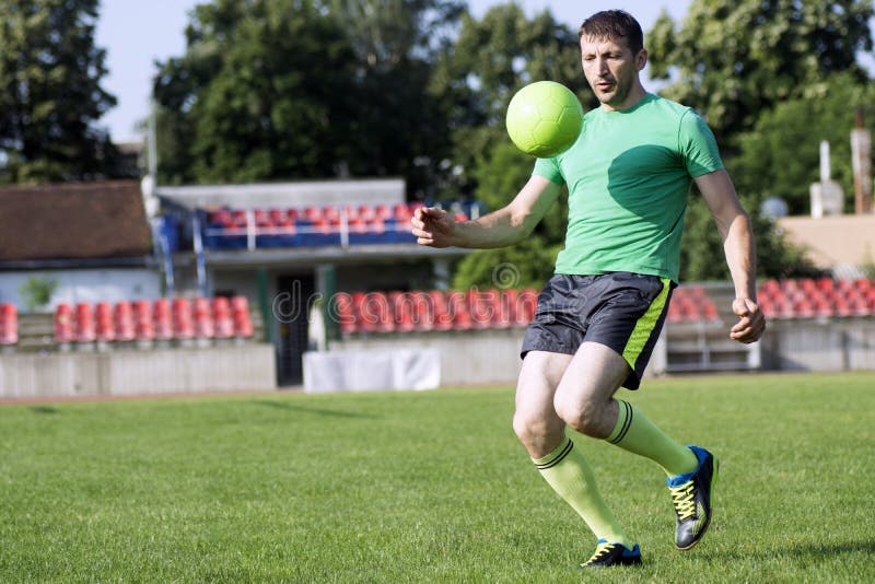 Playing football player stock photo. Image of field, green - 94478898