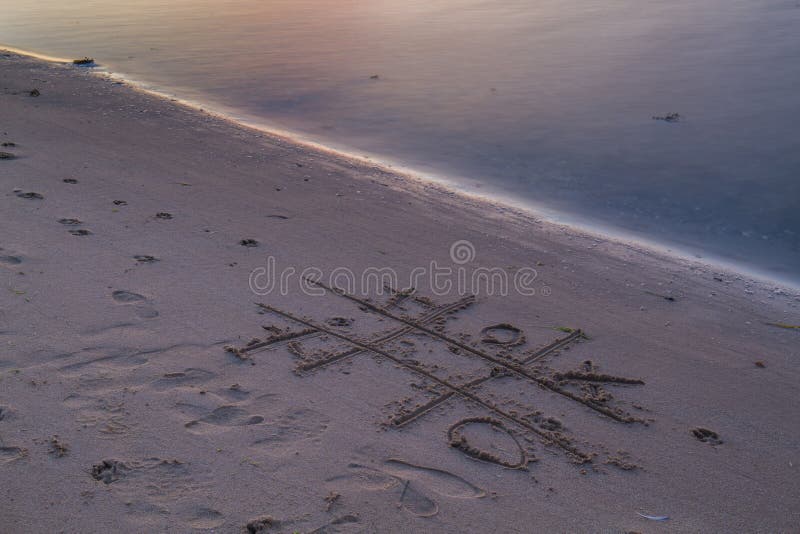 Playing a game in the sand stock image. Image of shoreline - 67799905