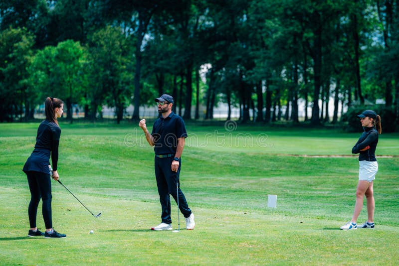 Playing Golf. Young Woman Playing Golf with Golf Instructor Stock Photo ...
