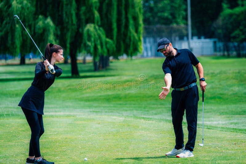 Playing Golf. Young Woman Playing Golf with Golf Instructor Stock Image ...