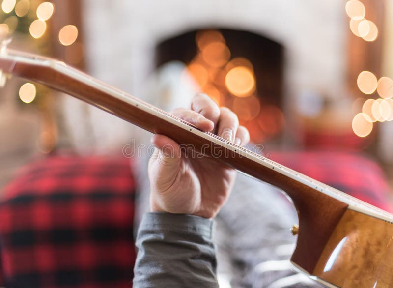 Playing Guitar by the Fireside Stock Image - Image of music, fireplace ...