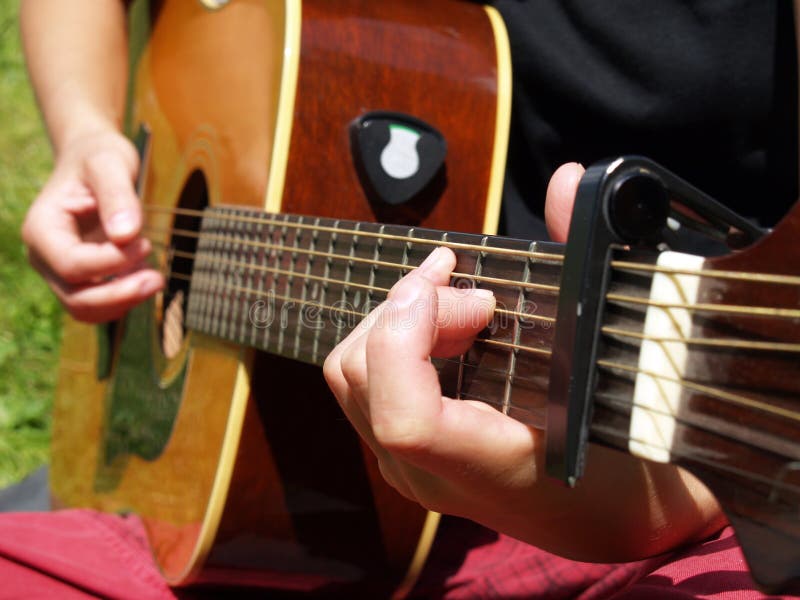 Playing the guitar outdoor stock photo. Image of instrument - 15012040