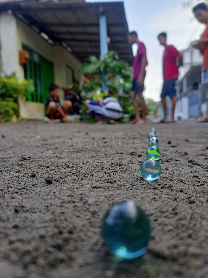 Kids Playing marbles photo stock image. Image of tradisional - 262400549 Kids Playing marbles photo stock image. Image of tradisional - 262400549