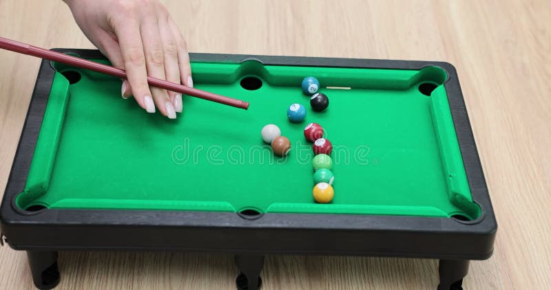 Playing Mini Billiards on a Small Table in Cozy Indoor Setting Stock ...