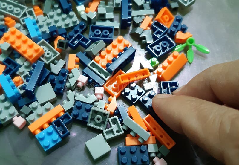 Playing with mini Legos stock image. Image of adult - 325960723