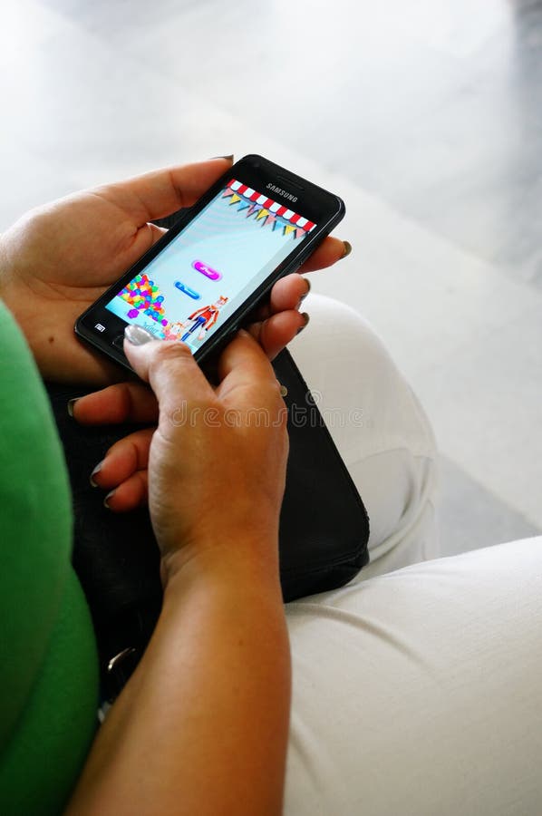 Playing phone games editorial photography. Image of touch - 36623342