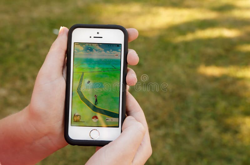 Playing Pokemon Go editorial photo. Image of screen, user - 75125966