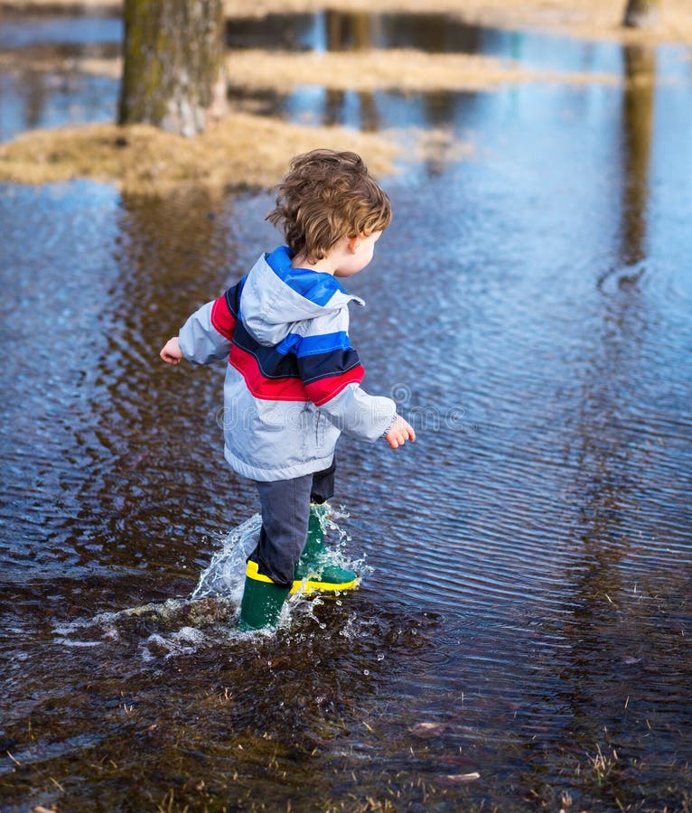 Playing in Puddles stock photo. Image of boots, lifestyle - 51514980