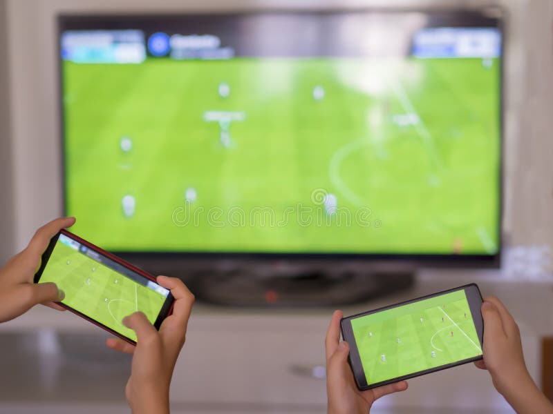 Boy Playing Football on Television Screen with Game Console Stock Photo ...