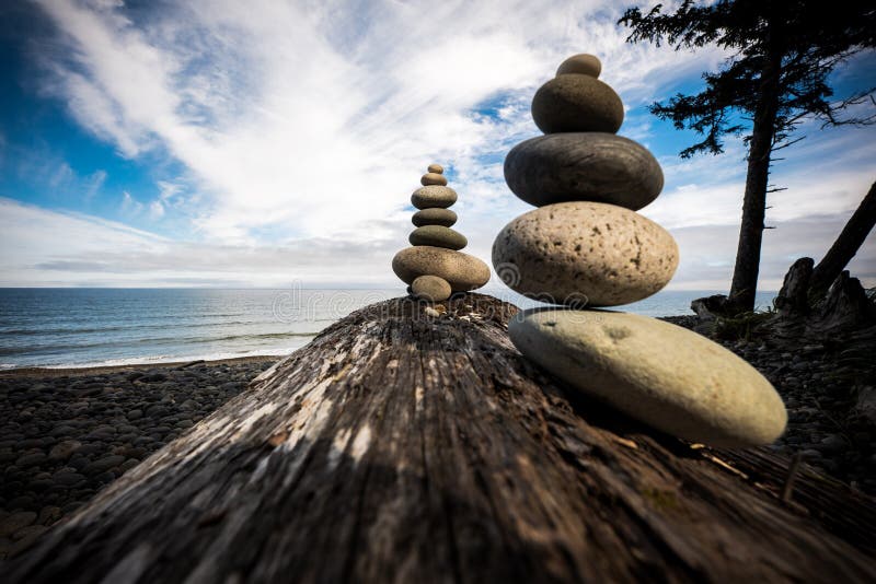 Playing with Stacking Rocks on a Log at Agate Beach, Haida Gwaii ...