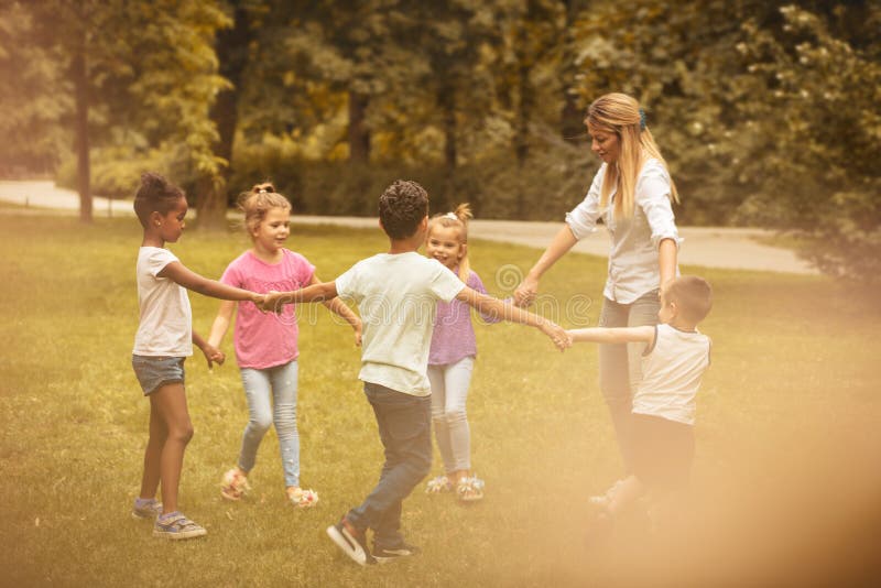Playing with teacher. stock photo. Image of holding - 121559740