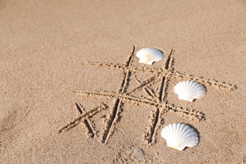 Playing Tic Tac Toe Game with Shells on Sand. Space for Text Stock ...