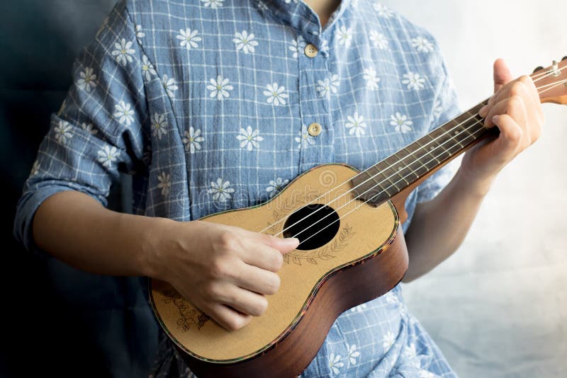 Playing ukulele stock image. Image of city, guitar, asian - 98143579