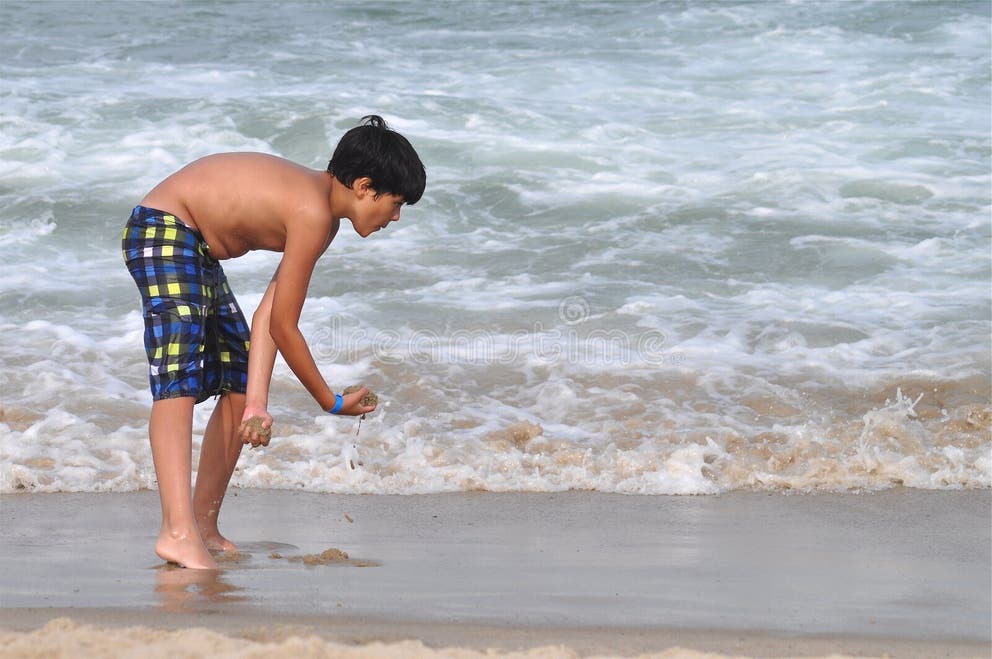 Playing with Wet Sand stock image. Image of holding, duck - 28390699
