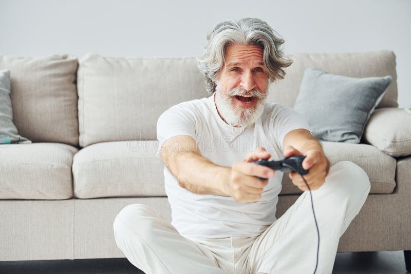 Plays Video Game by Using Controller. Senior Stylish Modern Man with ...