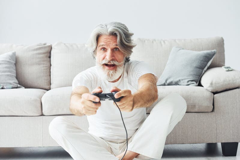 Plays Video Game by Using Controller. Senior Stylish Modern Man with ...